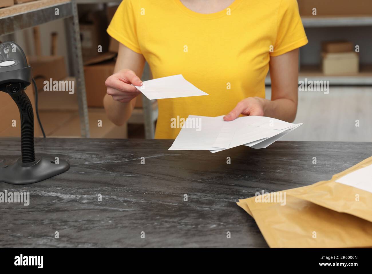 Post office worker with envelopes at counter indoors, closeup Stock ...