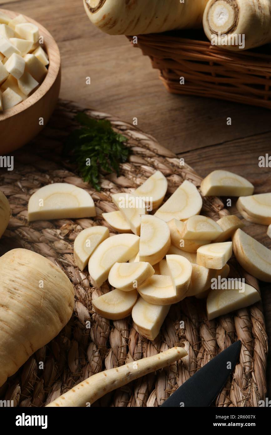Whole and cut parsnips on wooden table Stock Photo - Alamy