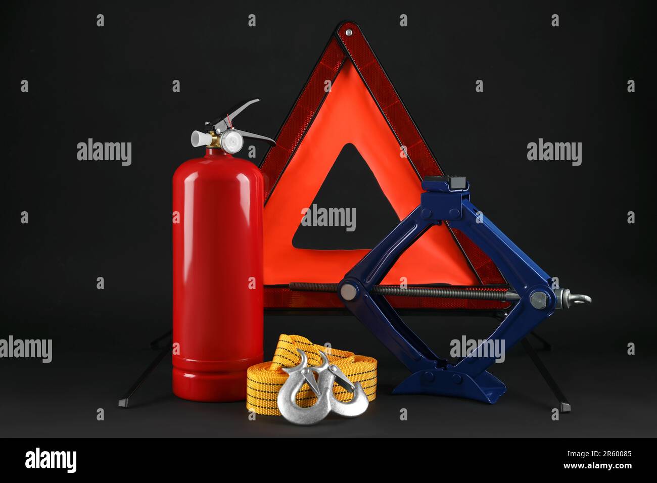 Emergency warning triangle, red fire extinguisher, towing strap and ...
