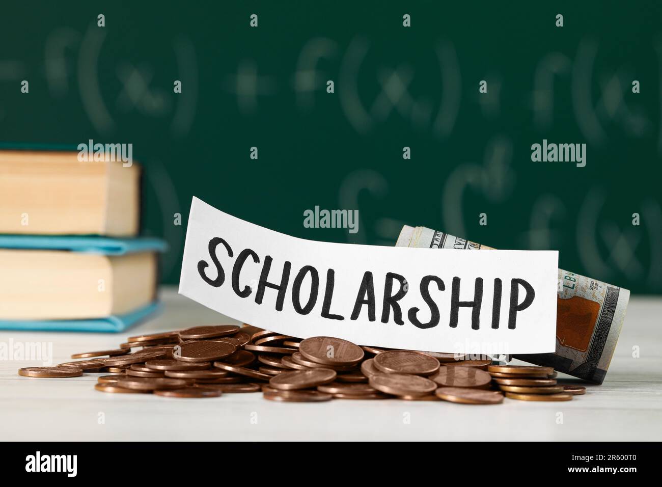 Sheet of paper with word Scholarship, coins and dollar banknotes on ...
