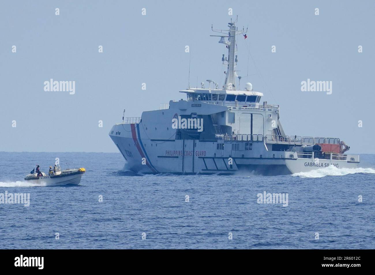 A small boat deployed by Japanese Coast Guard Akitsushima (PLH-32) passes by Philippine Coast ...