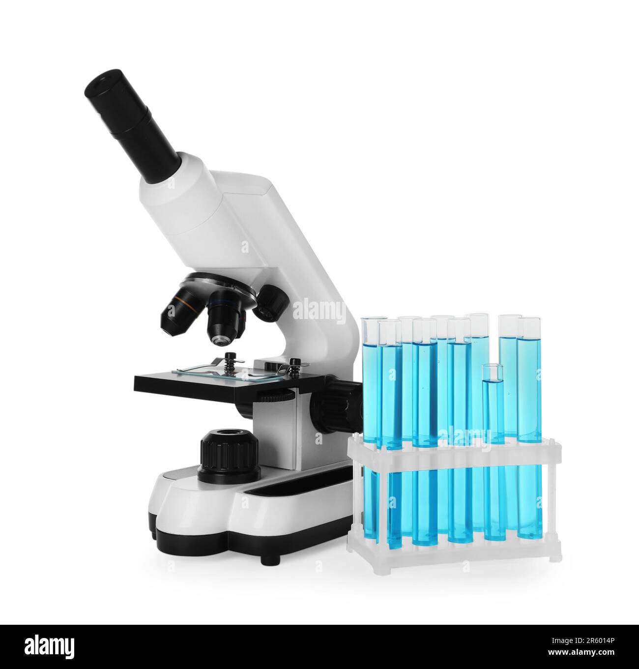 Test tubes with light blue liquid and microscope isolated on white ...