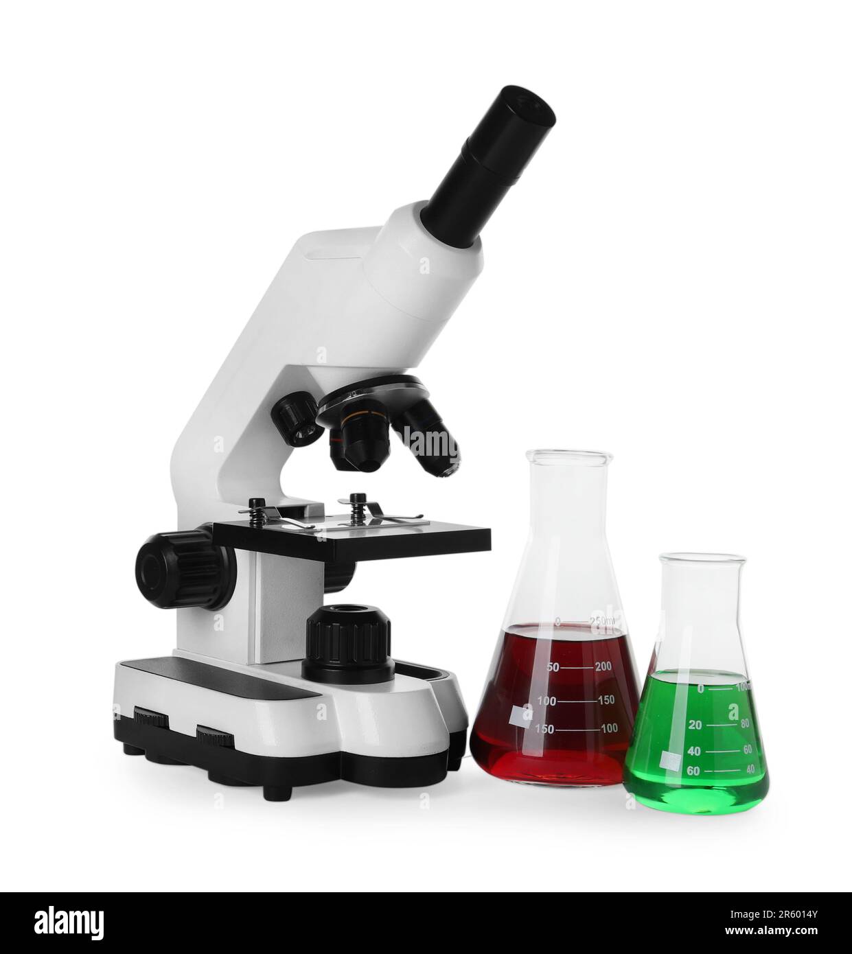 Laboratory glassware with colorful liquids and microscope isolated on ...