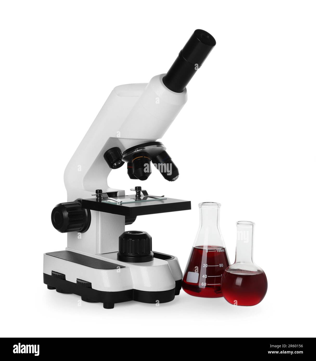 Laboratory glassware with red liquid and microscope isolated on white ...