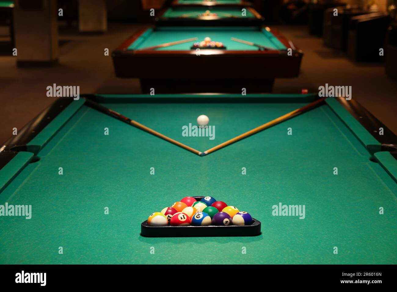 Billiard tables with balls and cues in club Stock Photo - Alamy