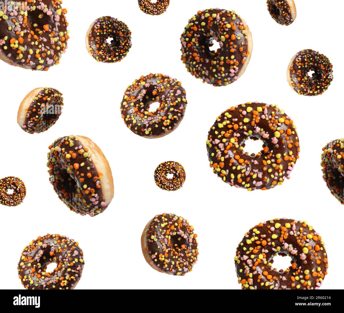 Many sweet tasty donuts falling on white background Stock Photo - Alamy