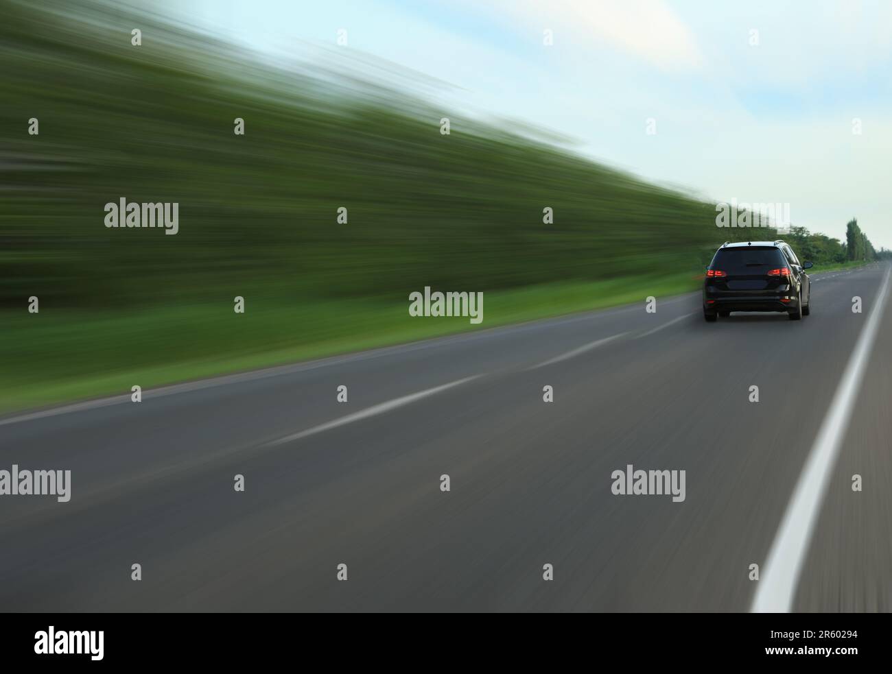 Black car driving at high speed on asphalt road outdoors, motion blur ...