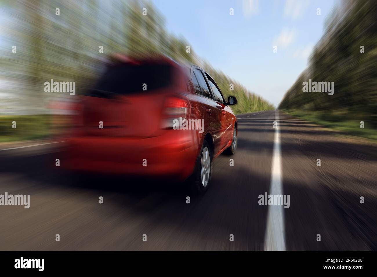 Red car driving at high speed on asphalt road outdoors, motion blur ...