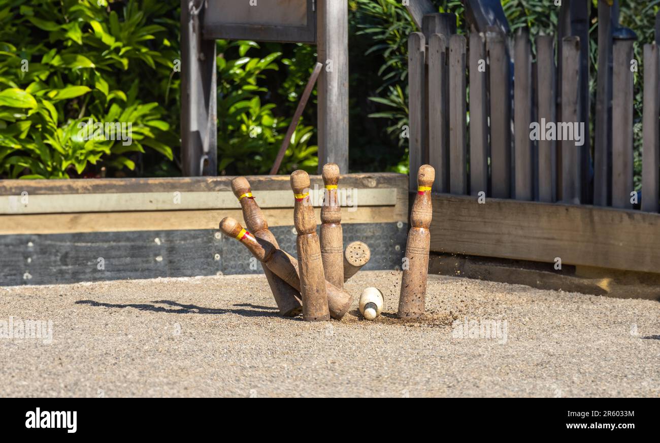 Moment of the impact of a small wooden skittle or bitllot against ...