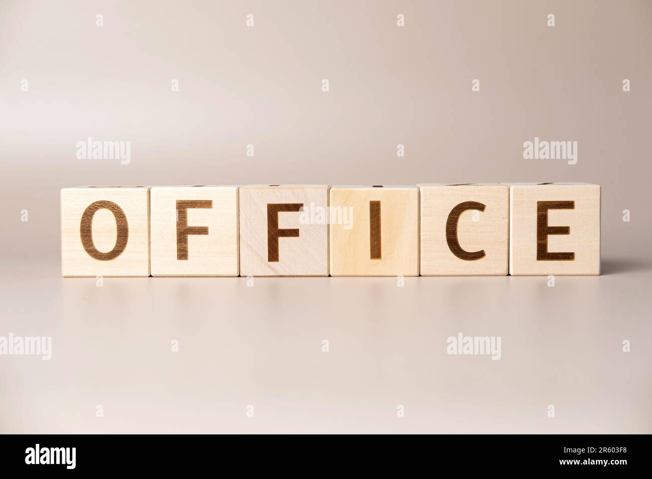 The word OFFICE on wooden cubes on a beige neutral studio background ...
