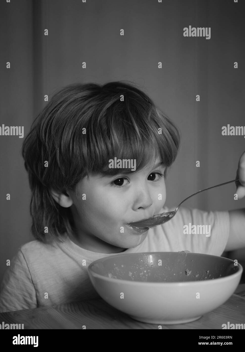 Kid eating. Little boy having breakfast in the kitchen. Food and Drink ...