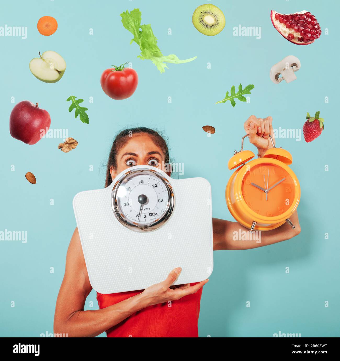 Scared woman is afraid of weight measurement with scale Stock Photo - Alamy