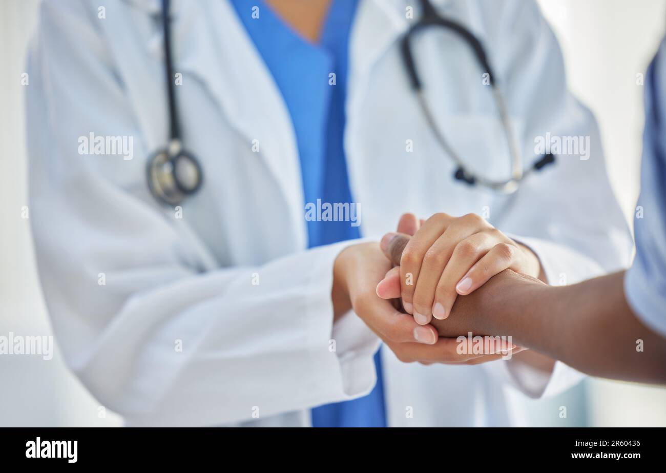 Doctor, holding hands and patient with support, help and grief ...