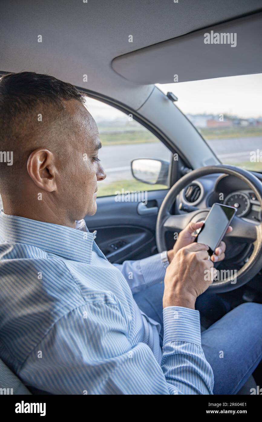 Driver using a mobile phone inside his car Stock Photo - Alamy