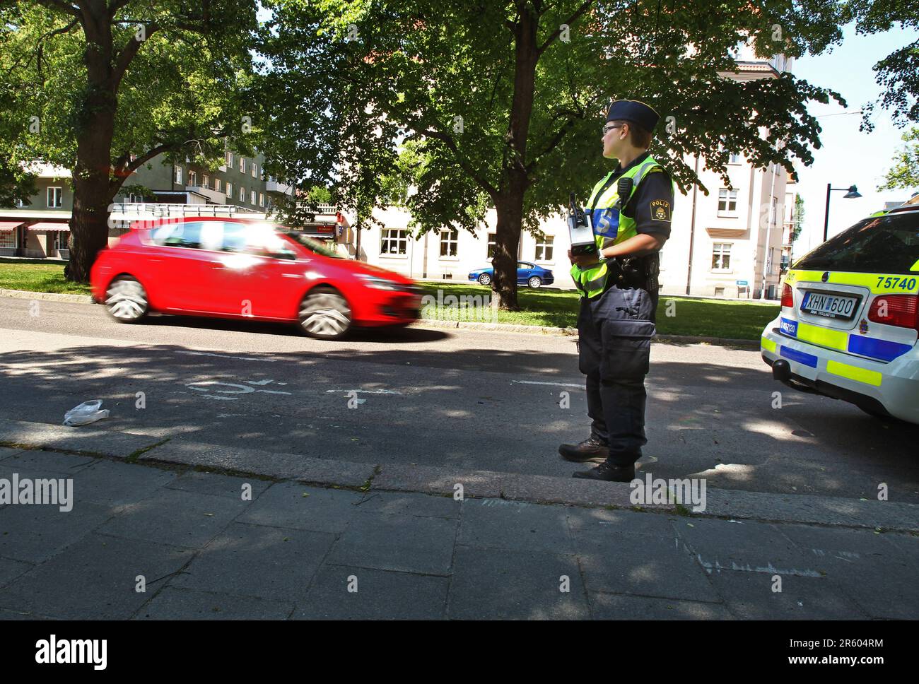 Traffic police with laser along a road in a city Stock Photo - Alamy