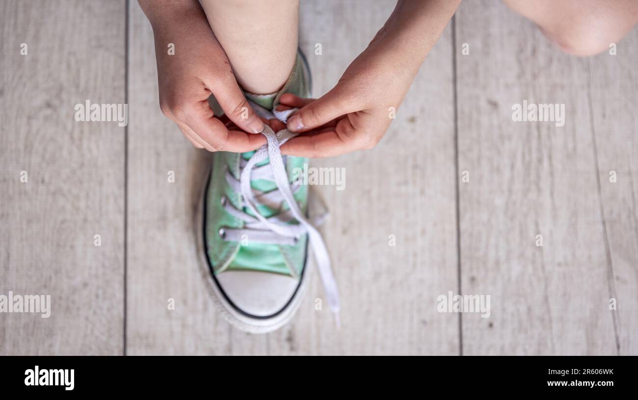 Child successfully ties shoes, close up on feet Stock Photo - Alamy