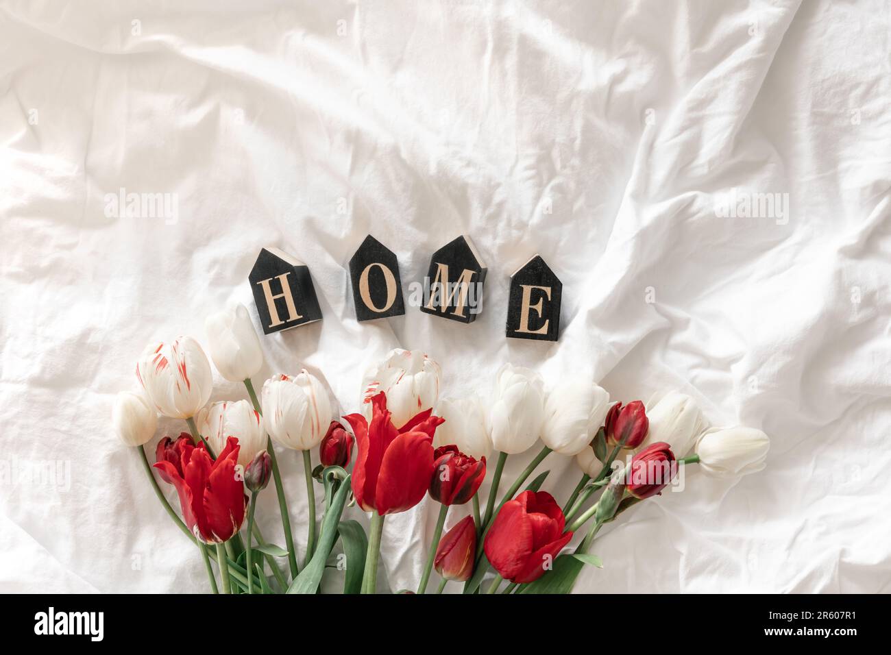Decorative word Home and tulips in a white bed, top view Stock Photo ...