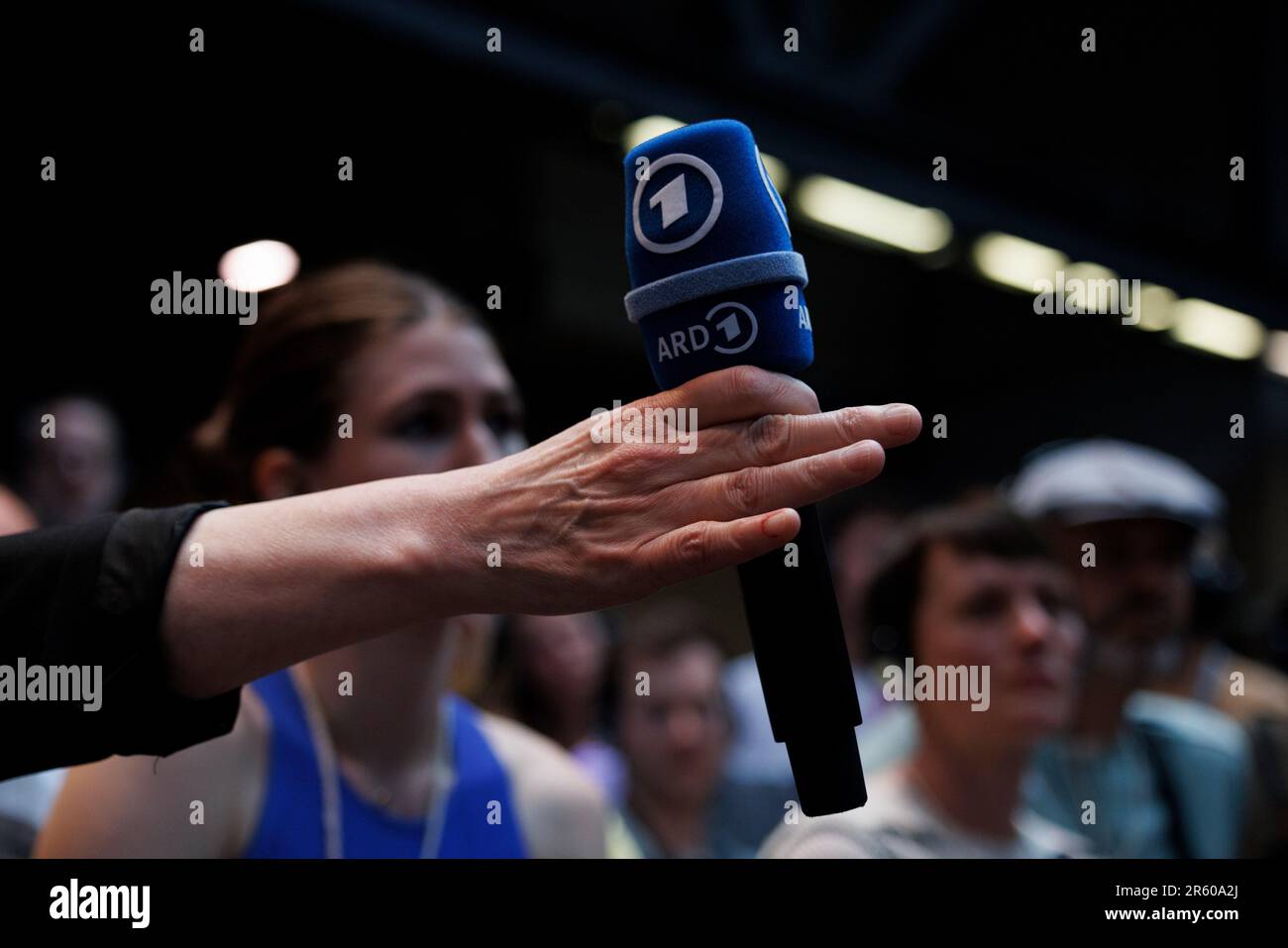 06 June 2023, Berlin: A visitor holds an ARD microphone in the ARD ...