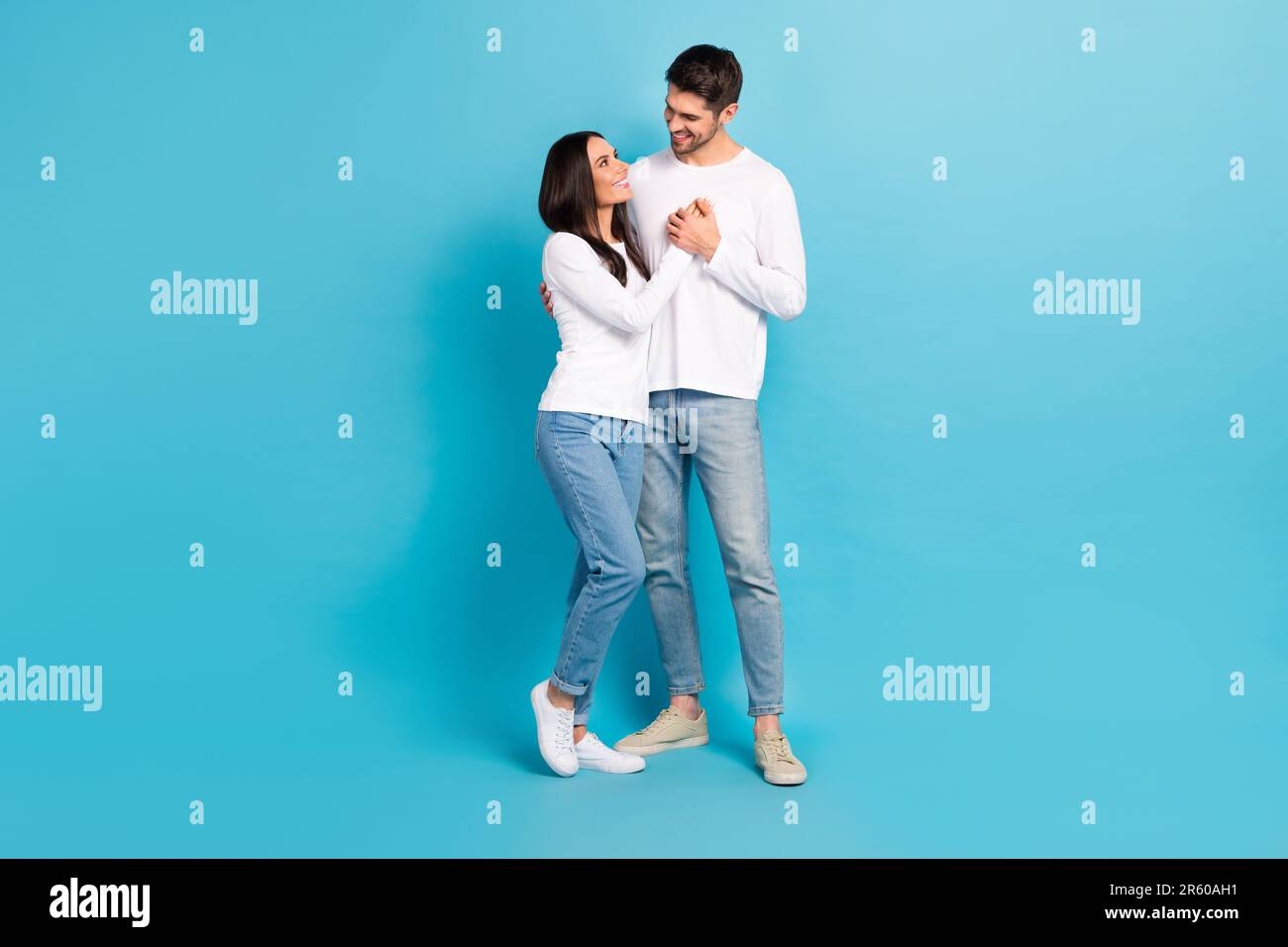 Full body photo of two idyllic positive people cuddle look each other ...
