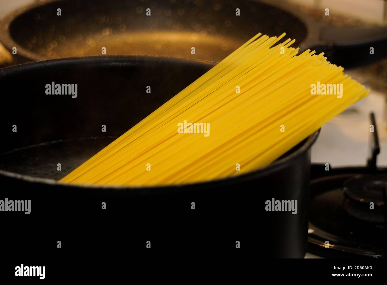 Spaghetti cooking in pot in the kitchen close up view Stock Photo - Alamy