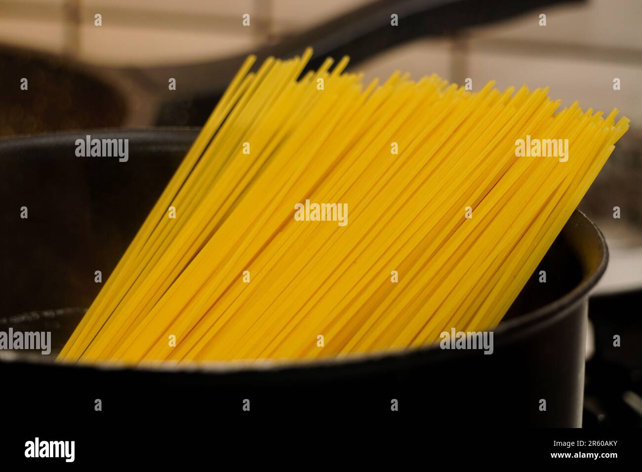 Spaghetti cooking in pot in the kitchen close up view Stock Photo - Alamy