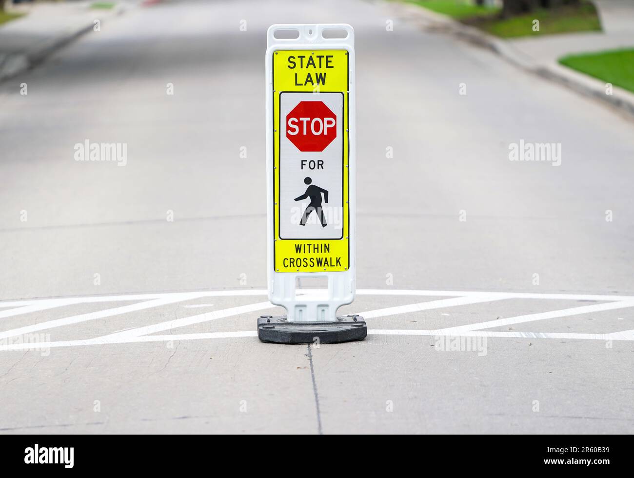 State Law Pedestrian Crosswalk Sign on a busy street in a neighborhood ...