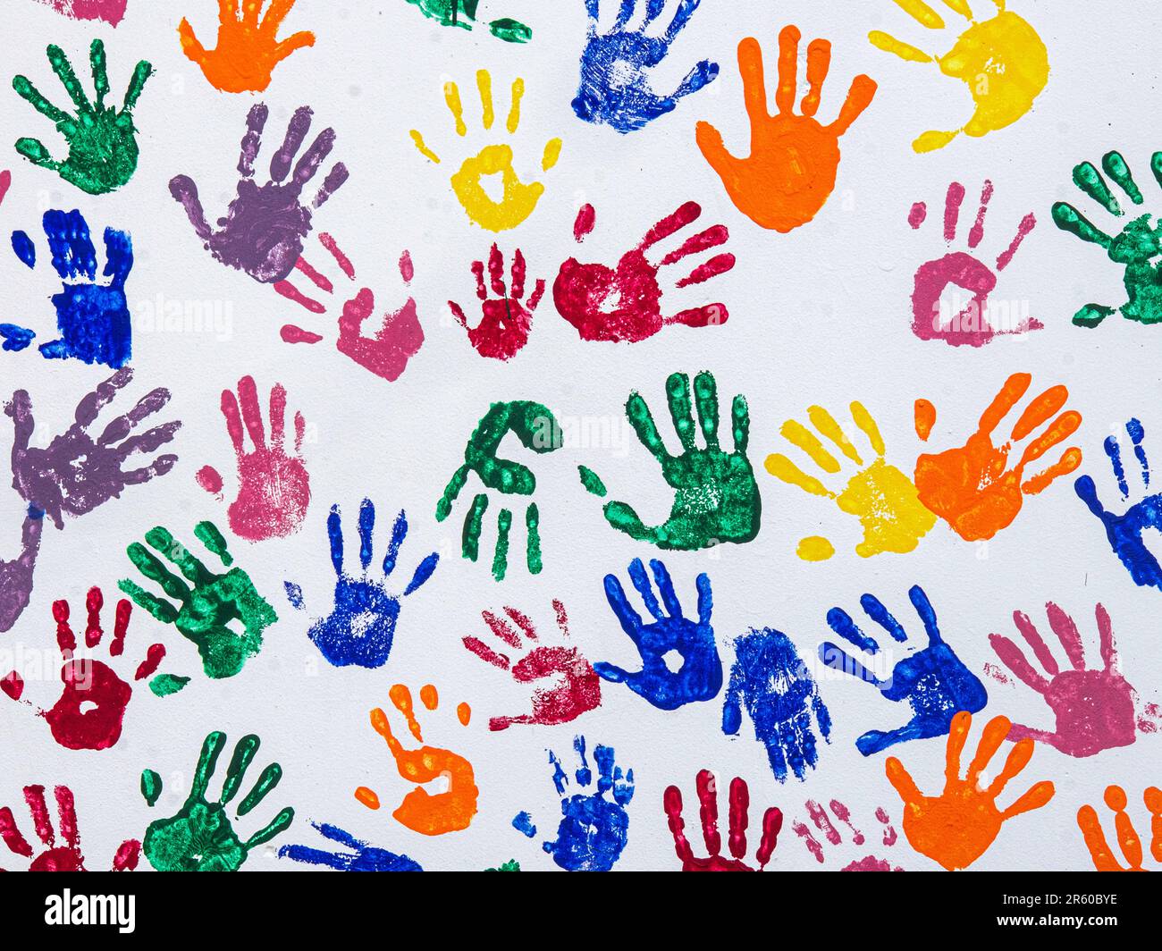 Colorful child's handprints on white background with red, orange, blue ...
