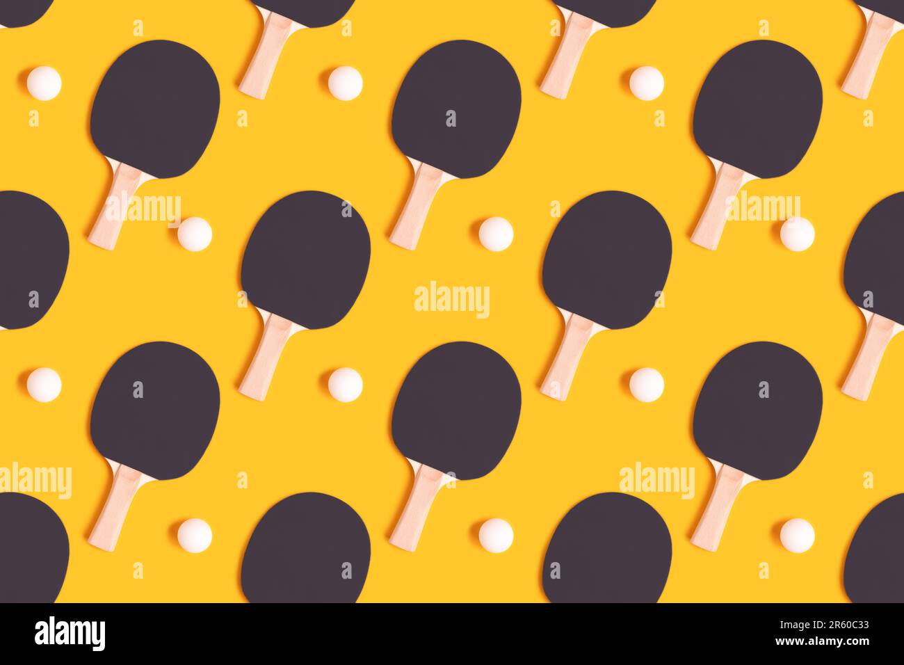Pattern made of tennis racket and white ball on a yellow background ...