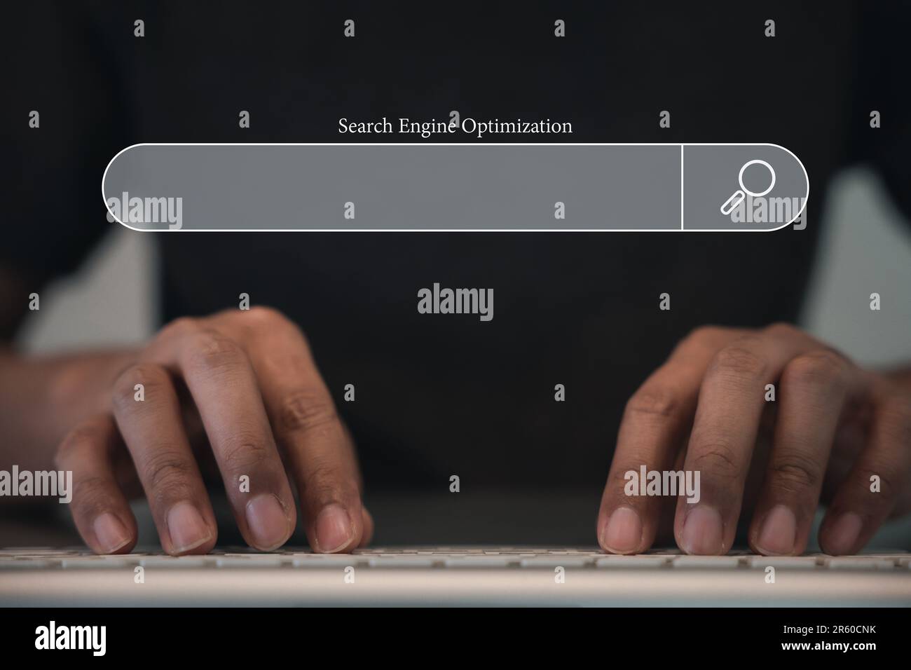 Man's hand on a keyboard, search icon on a dark network Stock Photo - Alamy