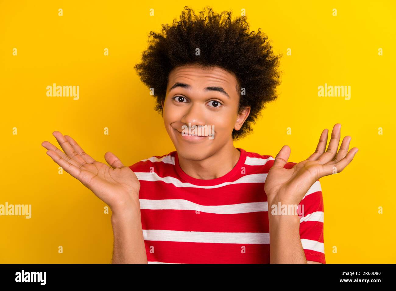 Photo of unsure uncertain man wear striped t-shirt rising arms ...