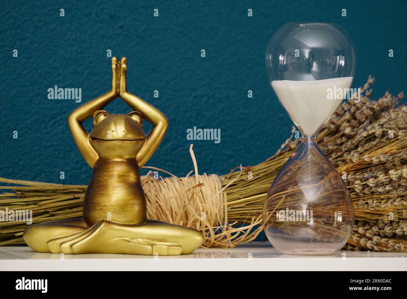 Tantra position frog figurine and sand clock close up view Stock Photo ...