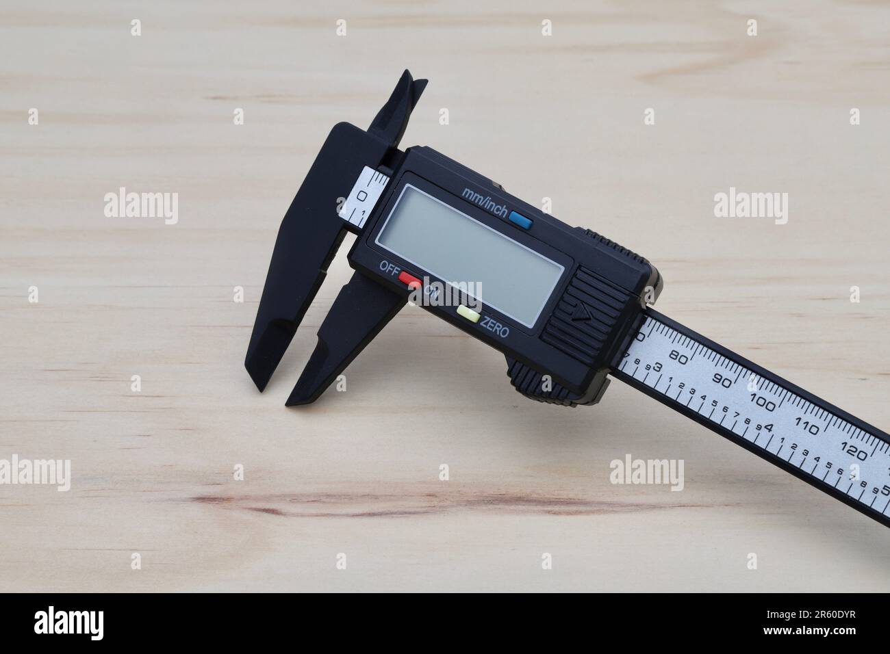 A close-up image of a digital electronic caliper, showing its stainless ...