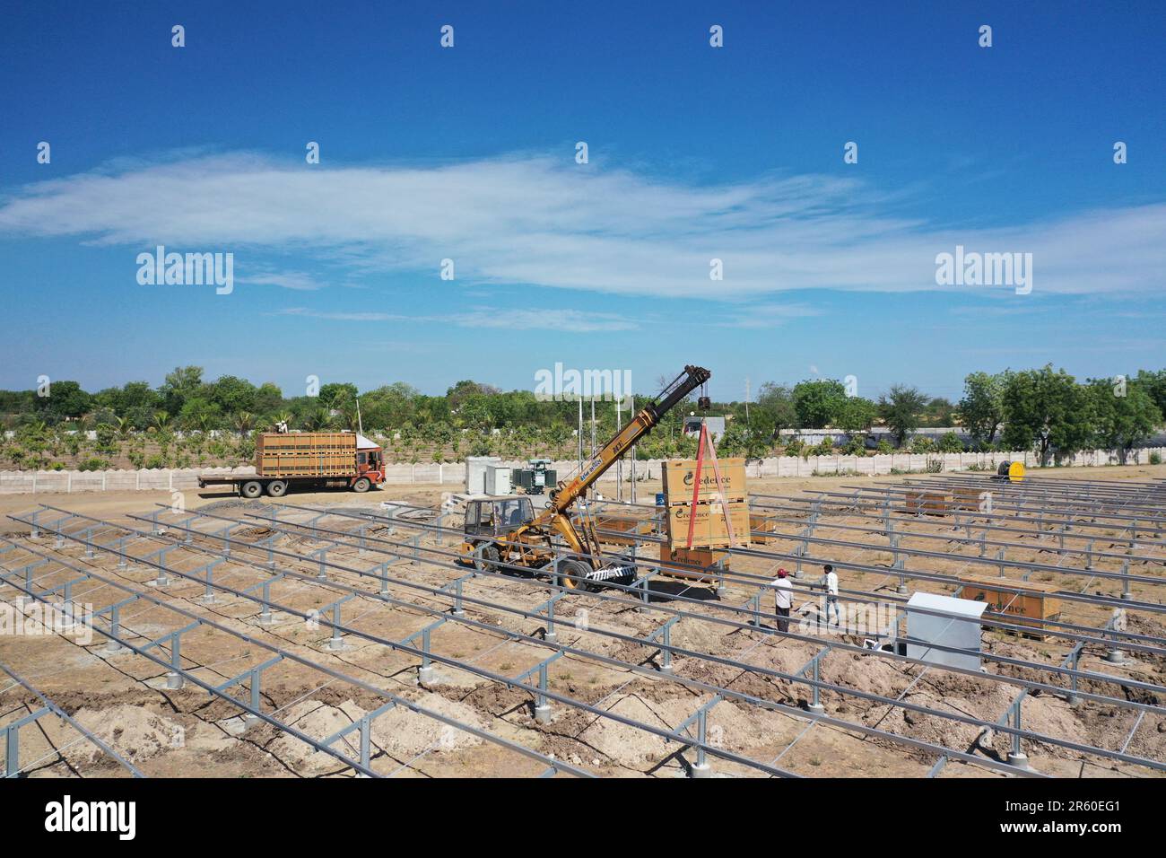 An array of solar panels installed in a rural field, with electrical ...