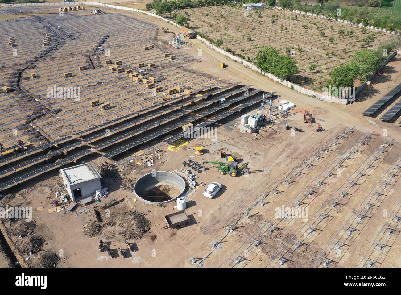 An array of solar panels installed in a rural field, with electrical ...