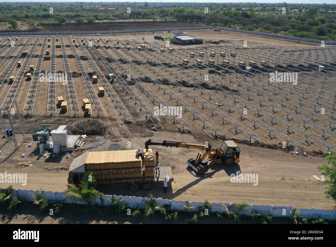 An array of solar panels installed in a rural field, with electrical ...