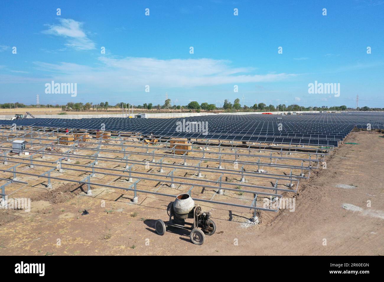 An array of solar panels installed in a rural field, with electrical ...