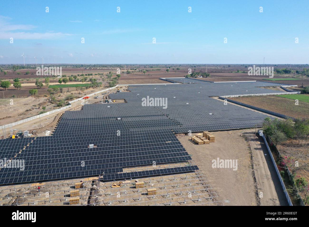 This image shows a construction site with a series of solar panels set ...