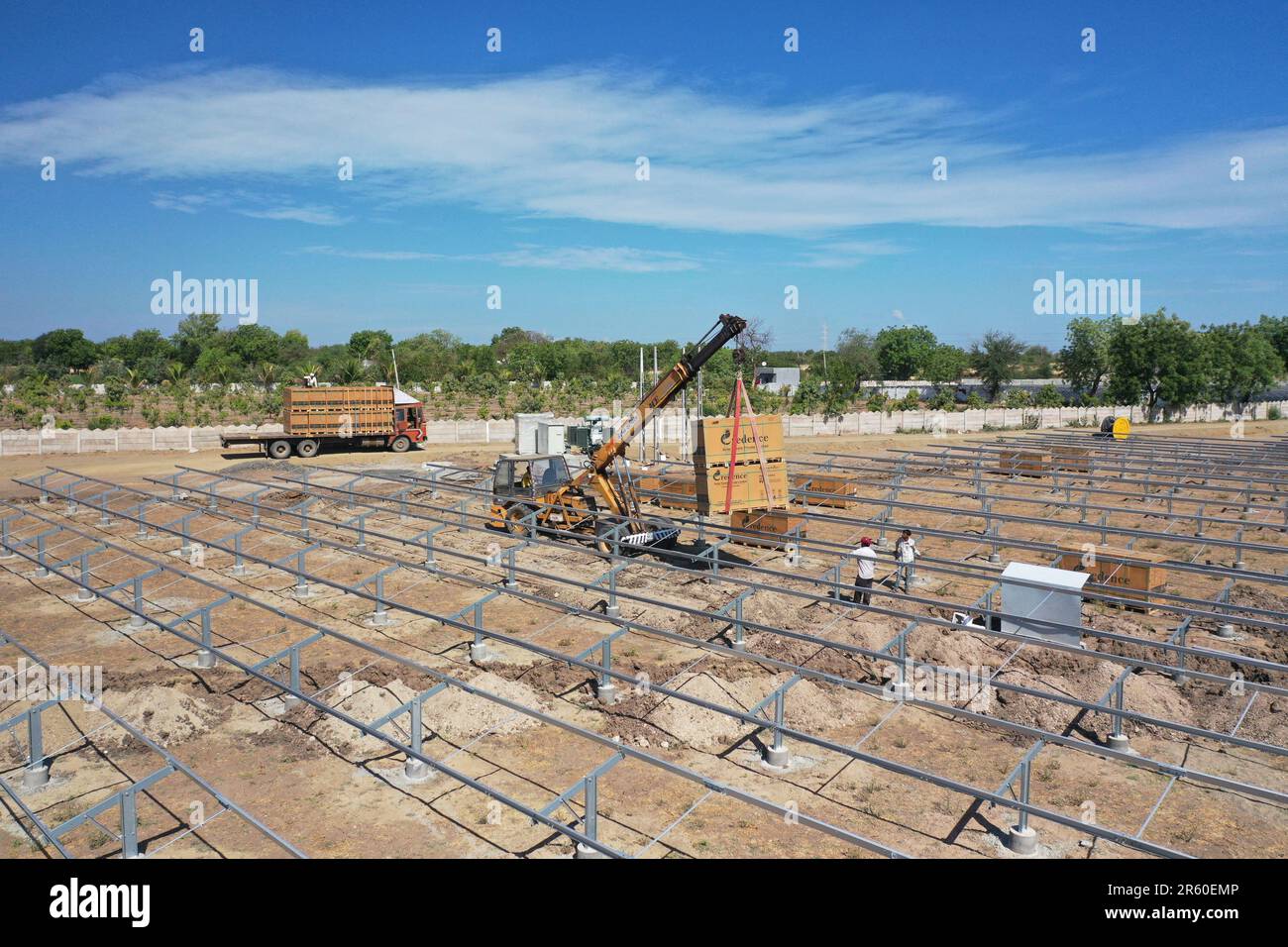 An array of solar panels installed in a rural field, with electrical ...