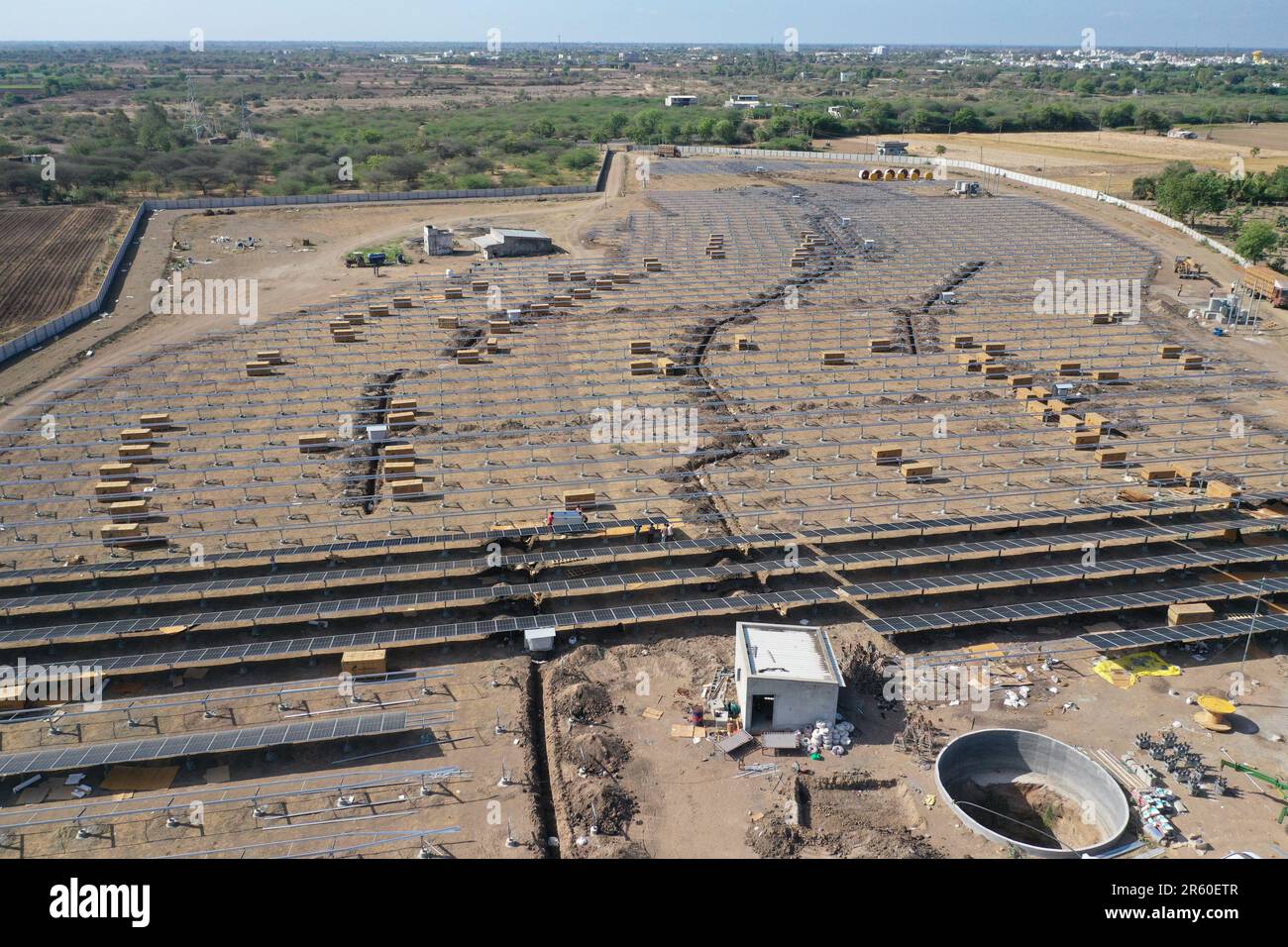 An array of solar panels installed in a rural field, with electrical ...
