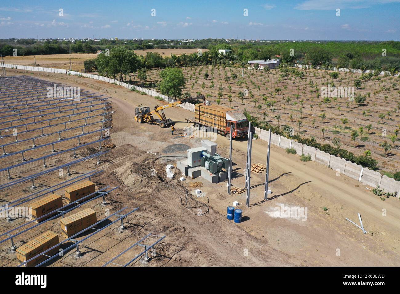 An array of solar panels installed in a rural field, with electrical ...