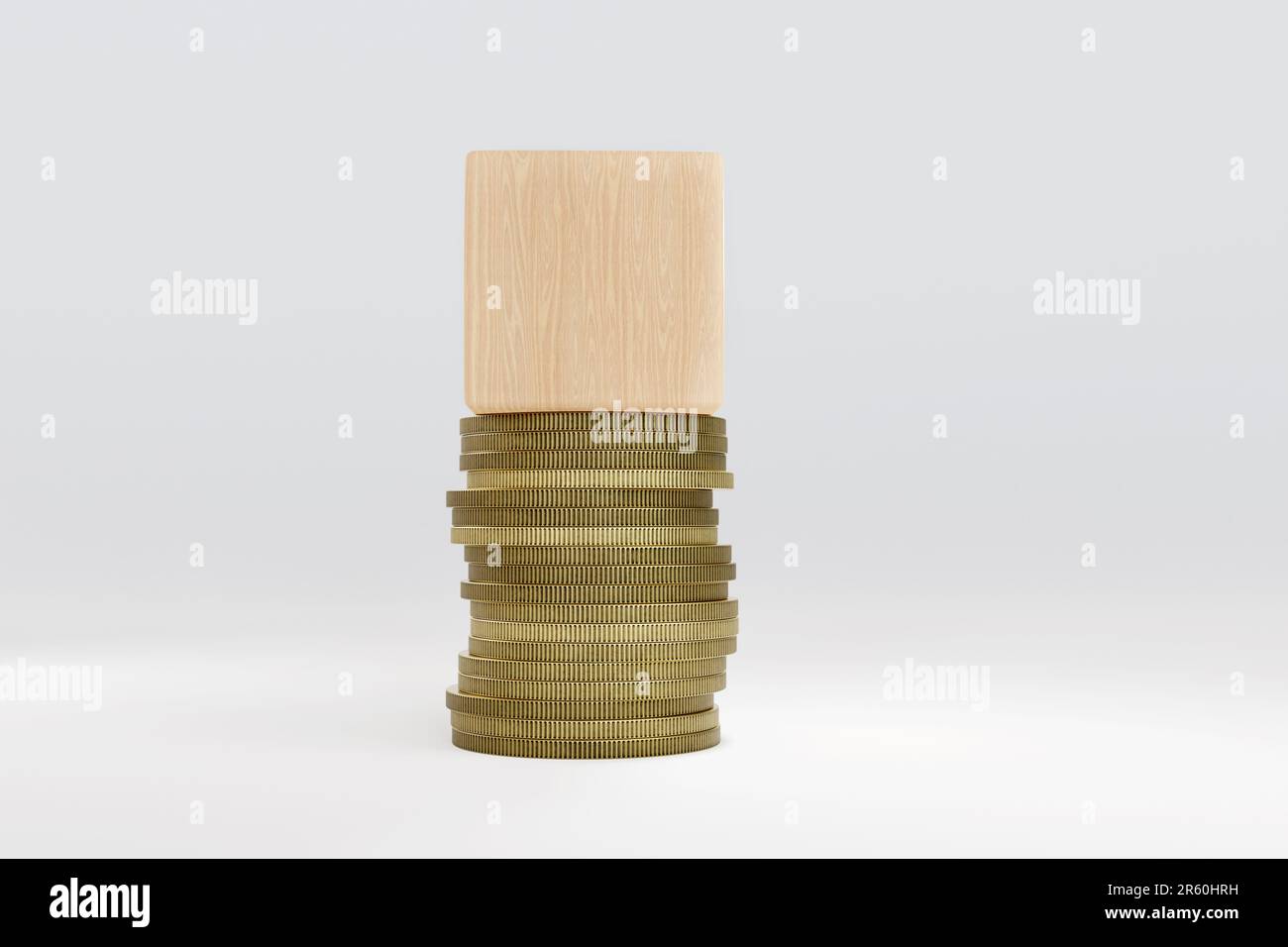 Stack of golden coins topped with a wooden block which acts as a copy ...