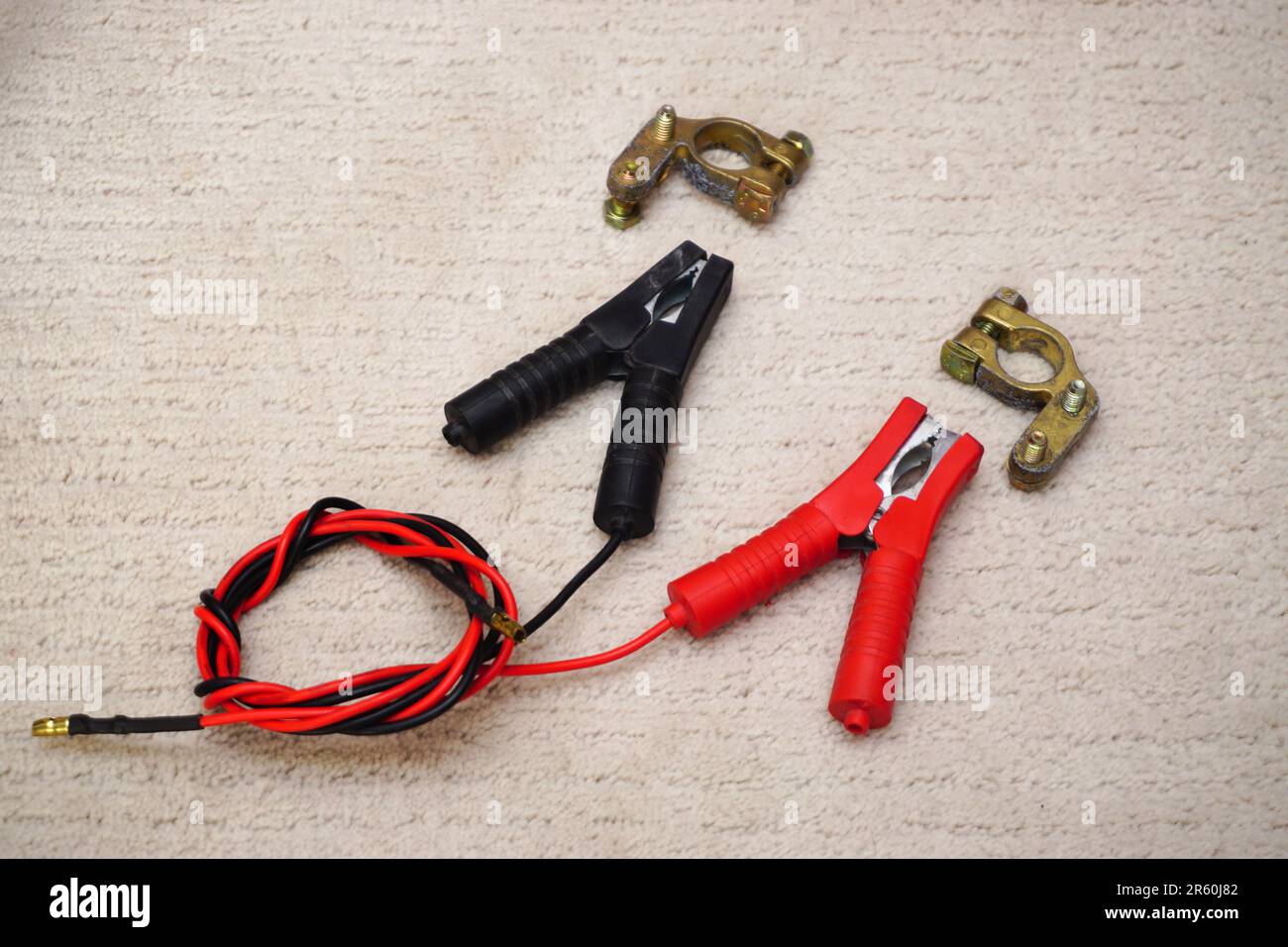 Battery clamps on isolated background close up view Stock Photo - Alamy
