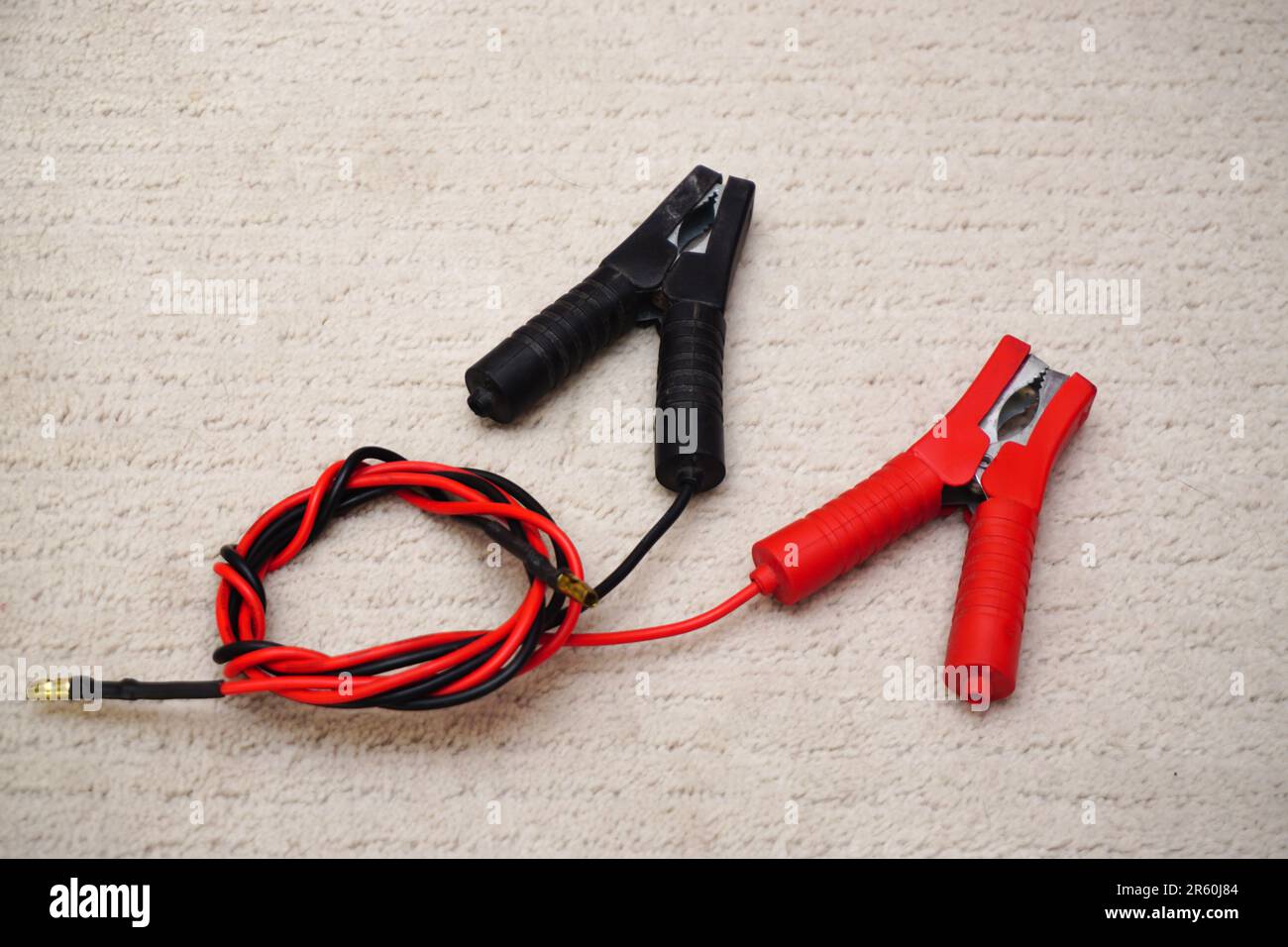 Battery clamps on isolated background close up view Stock Photo - Alamy