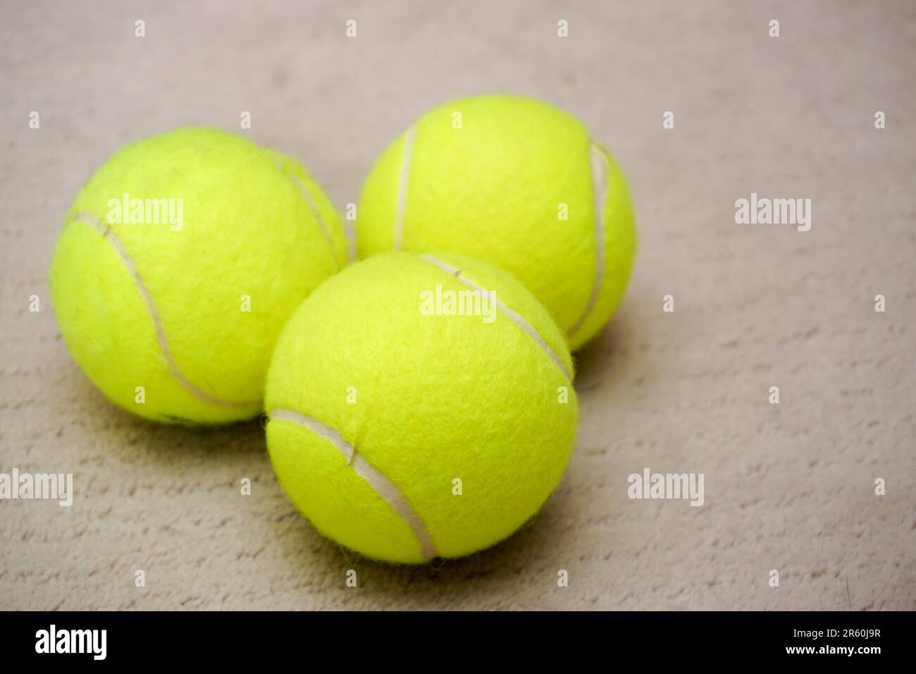 Three tennis balls on isolated background Stock Photo - Alamy