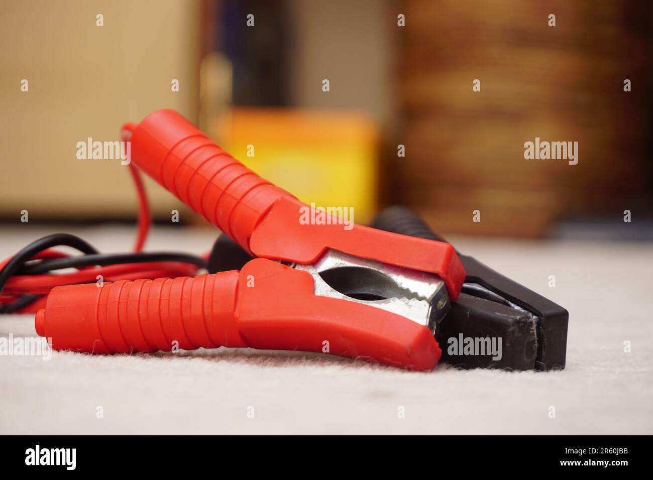 Battery clamps on isolated background close up view Stock Photo - Alamy