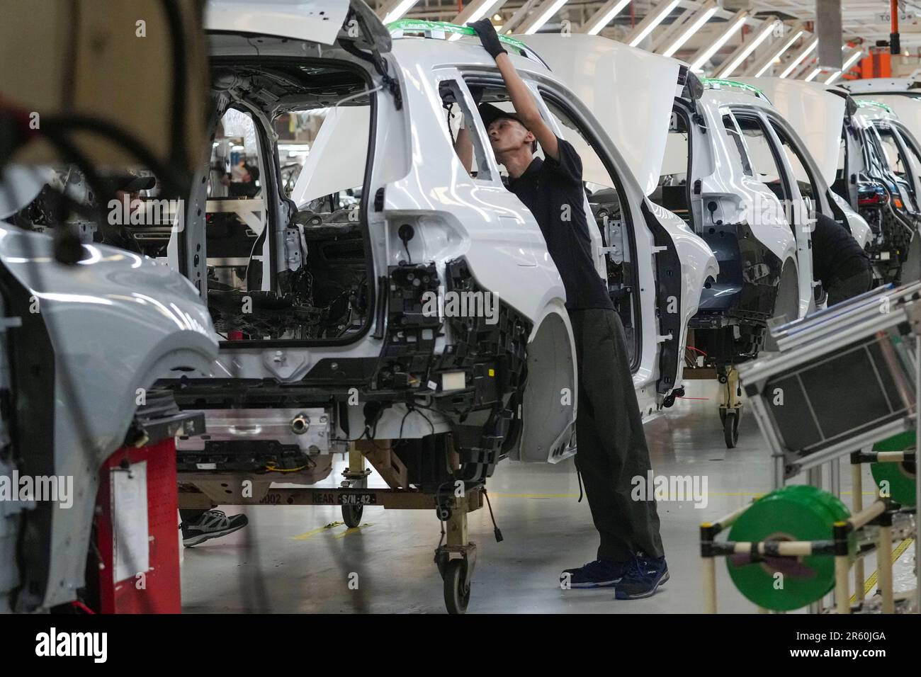 An employee works on a car on the assembly line at the BMW Production ...