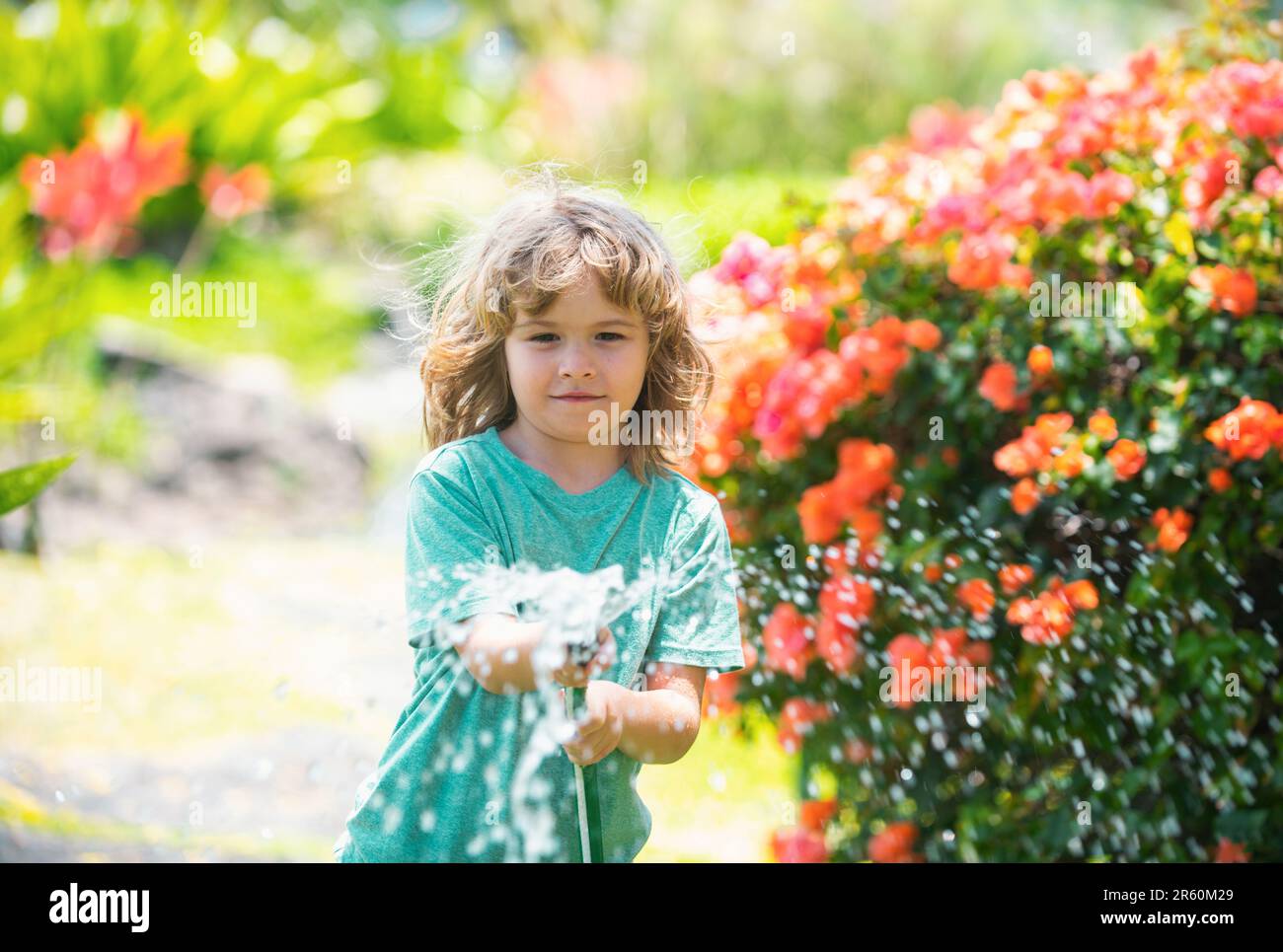 Kids play with water garden hose in yard. Outdoor children summer fun ...