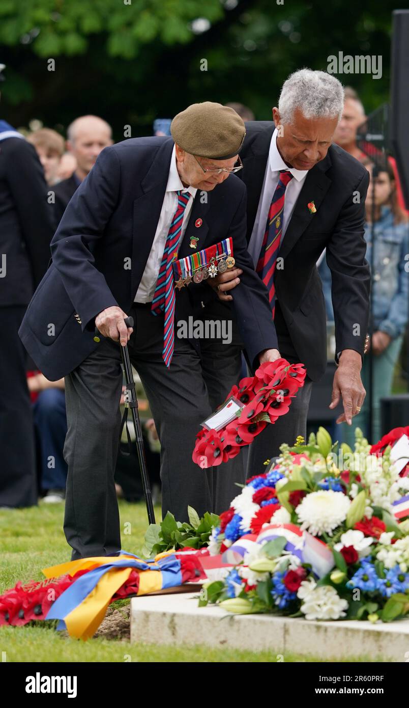 D-Day veteran Reg Pye (left) is helped to lay a wreath during the Royal ...