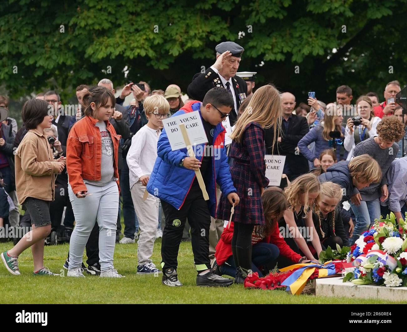 Normandy Veteran Terry Burton helps children to lay wreaths during the ...