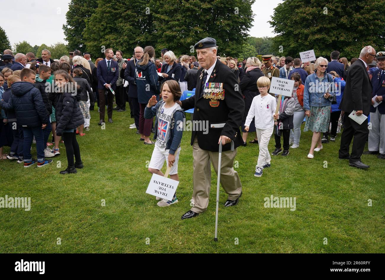 Normandy Veteran Terry Burton helps children to lay wreaths during the ...